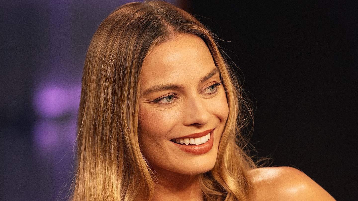 Margot Robbie Embraces Peek-a-Boo Trend at Paris Fashion Week
