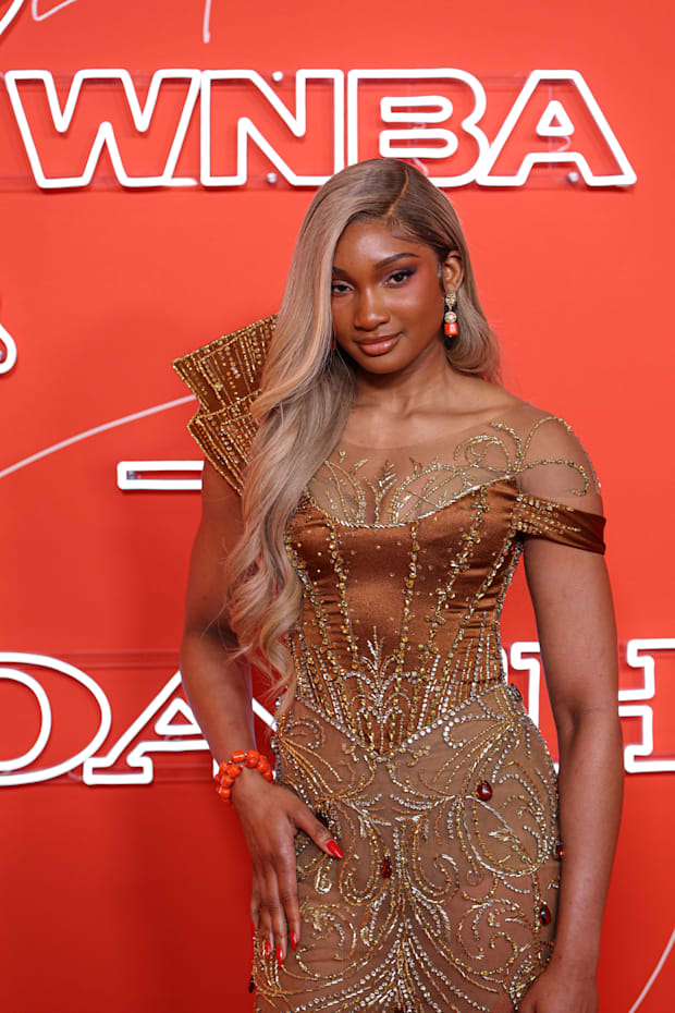 Kiki Iriafen has startling gold goddess transformation for WNBA draft orange carpet