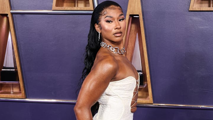 Jordan Chiles flexes bikini tattoo on waist during SI Swimsuit runway show