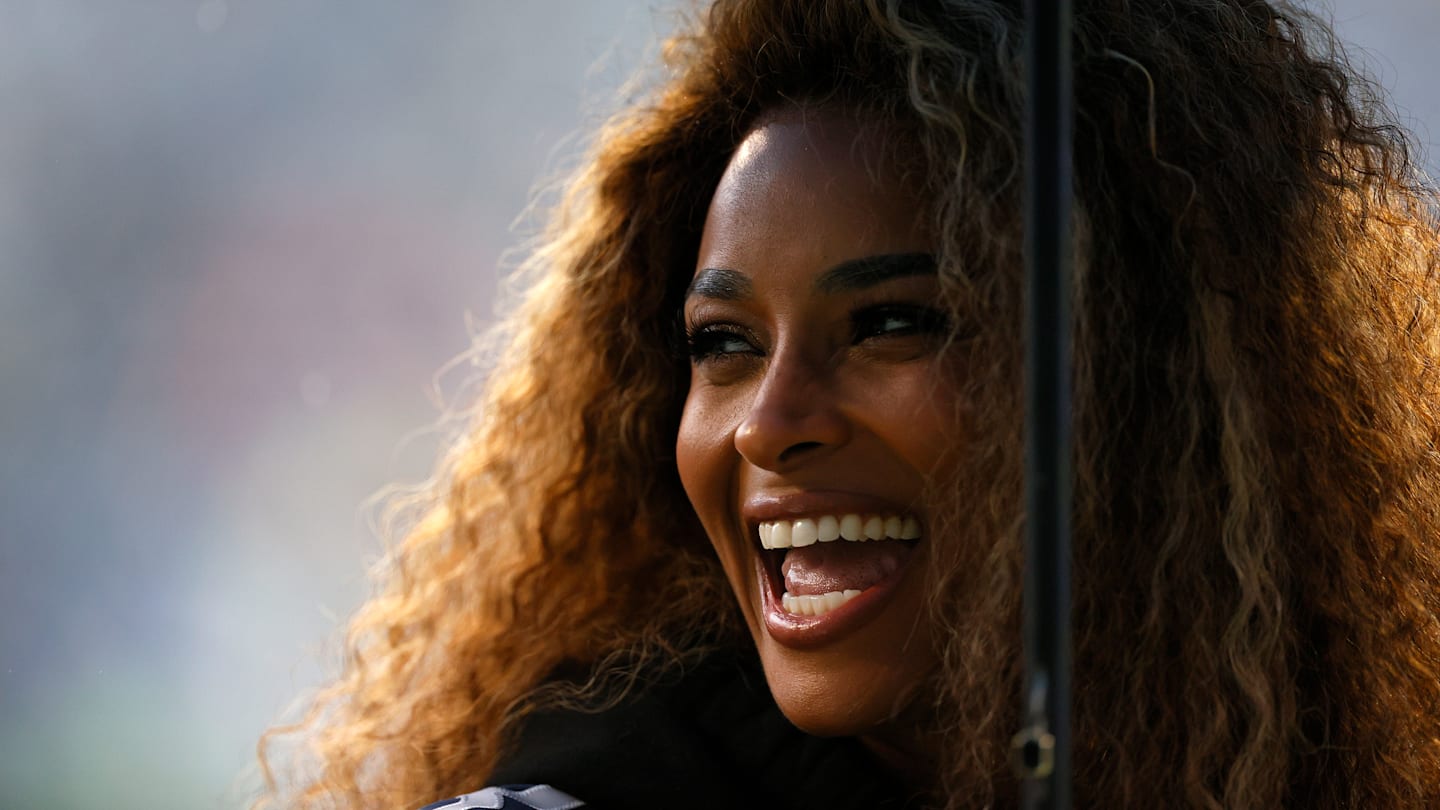 Ciara sizzles in red swimsuit while posing by pool side