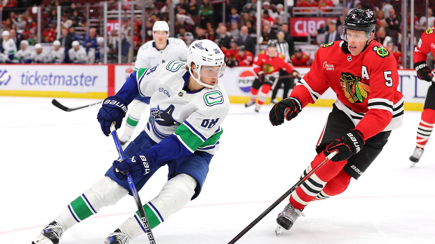 Canucks make two surprising roster moves; Top prospect stays put... for now