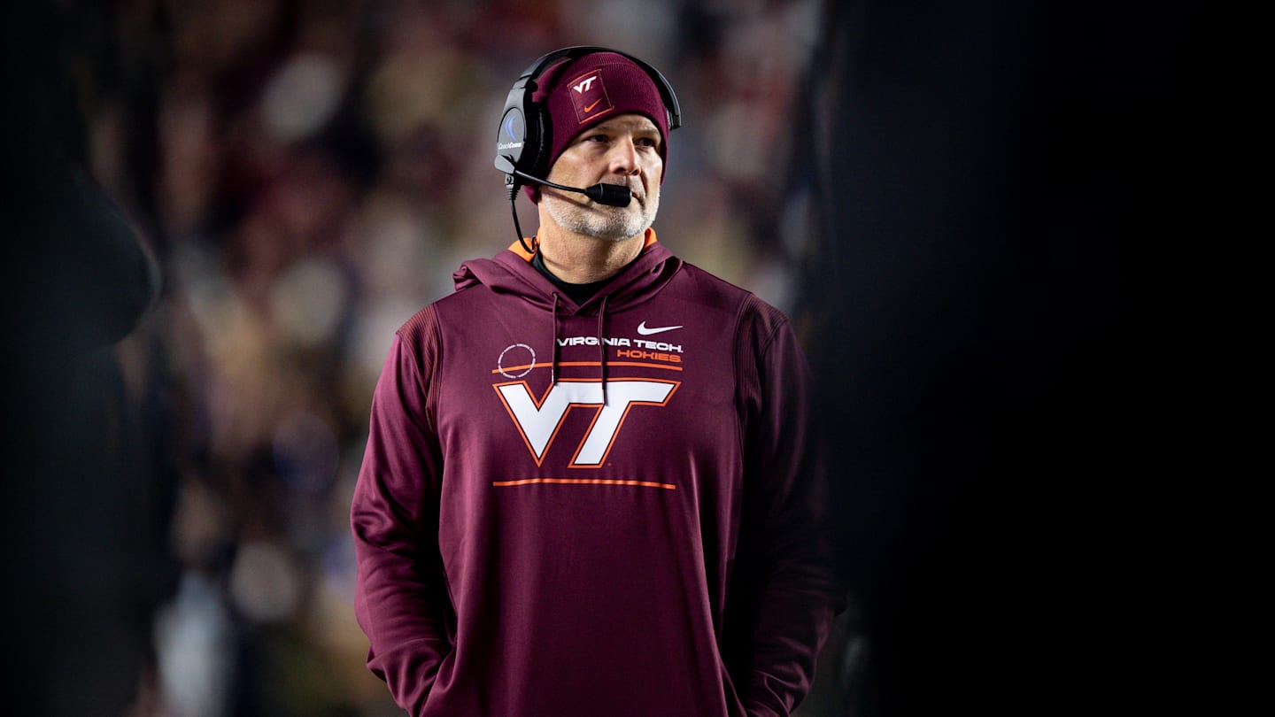 Former Virginia Tech football coach Justin Fuente putting the headset ...