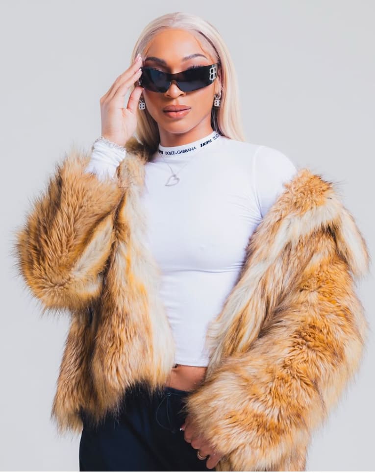 WNBA star DiJonai Carrington’s fur coat perfectly matches her furry lap dog