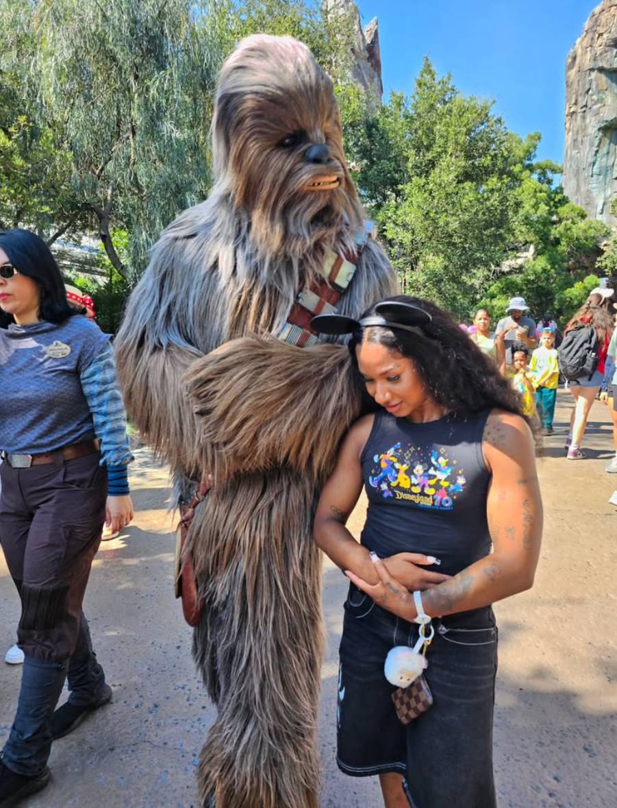 4-foot-11 Jordan Chiles towered over by giant Chewbacca at Disneyland ...